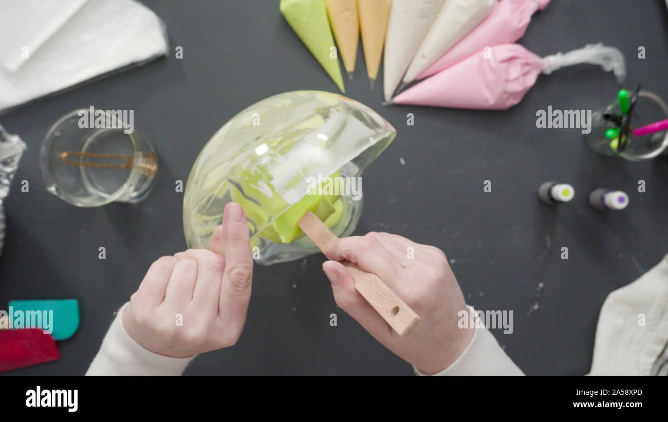 Step by step. Flat lay. Pouring royal icing into the piping bag to ...