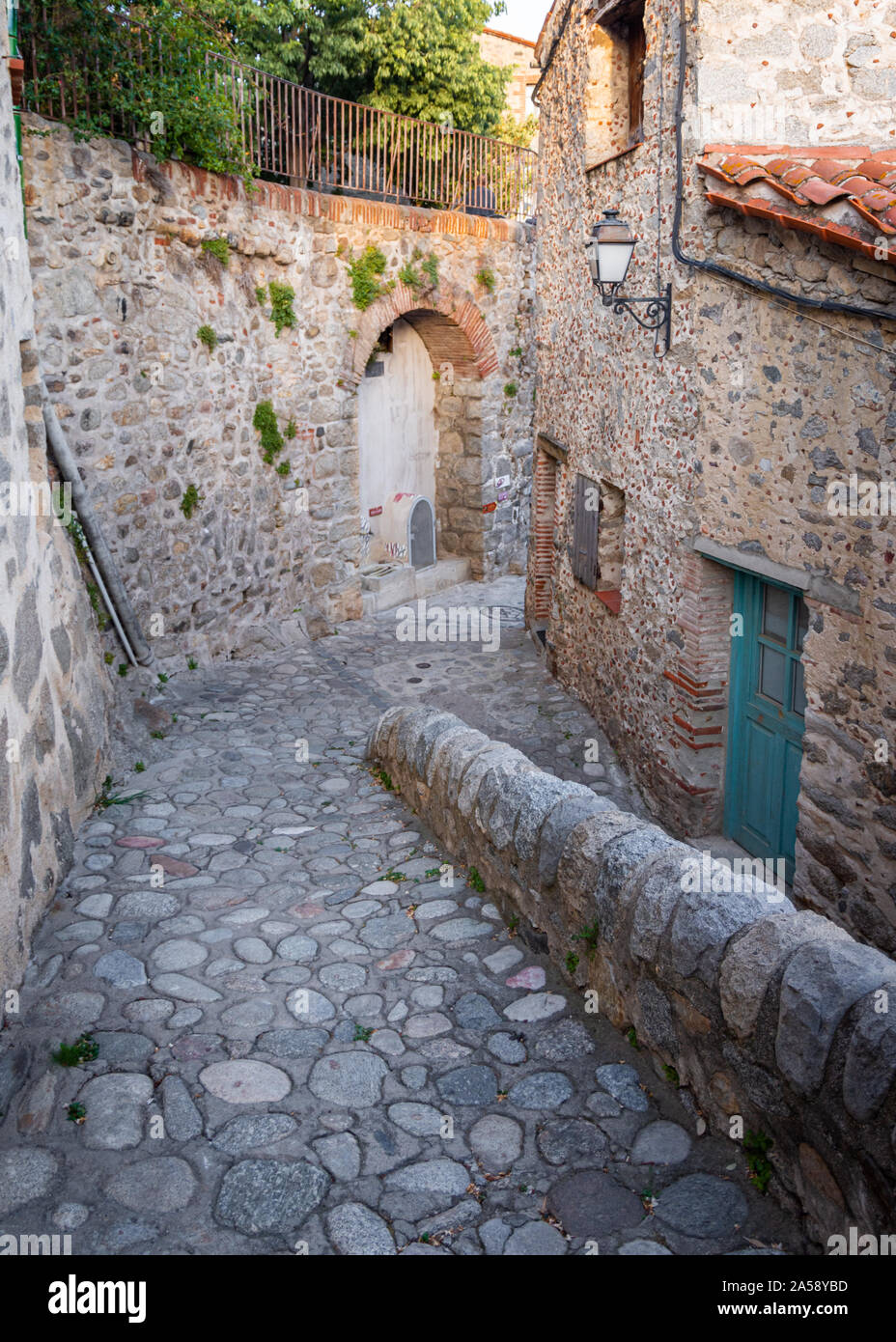 Cobblestone street in the pretty village of Eus, Pyrenees-Orientales ...