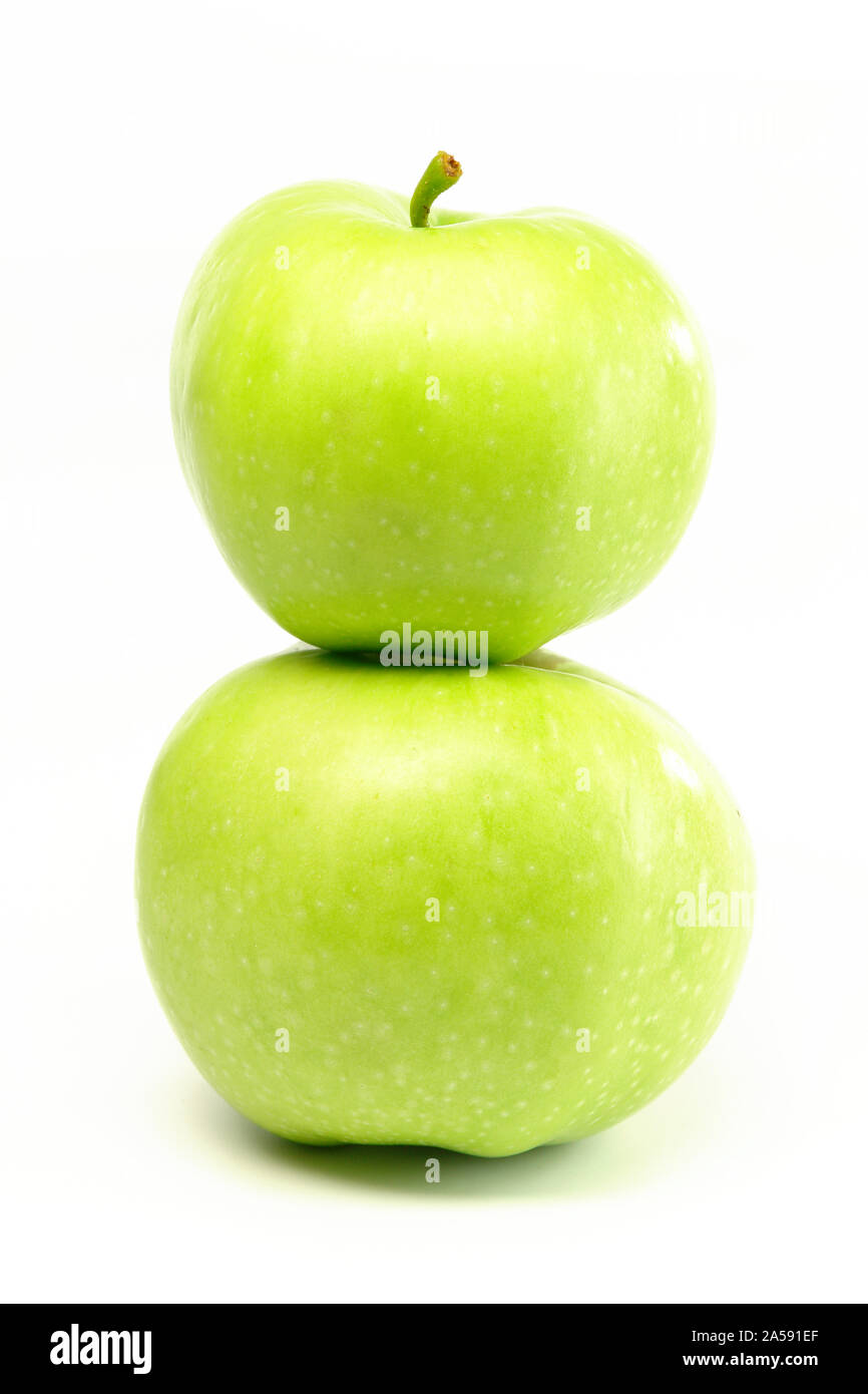 Two green apple on white background Stock Photo - Alamy