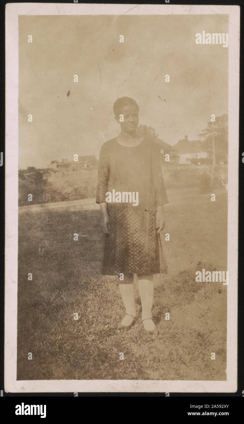 Unidentified young woman standing outside Stock Photo - Alamy