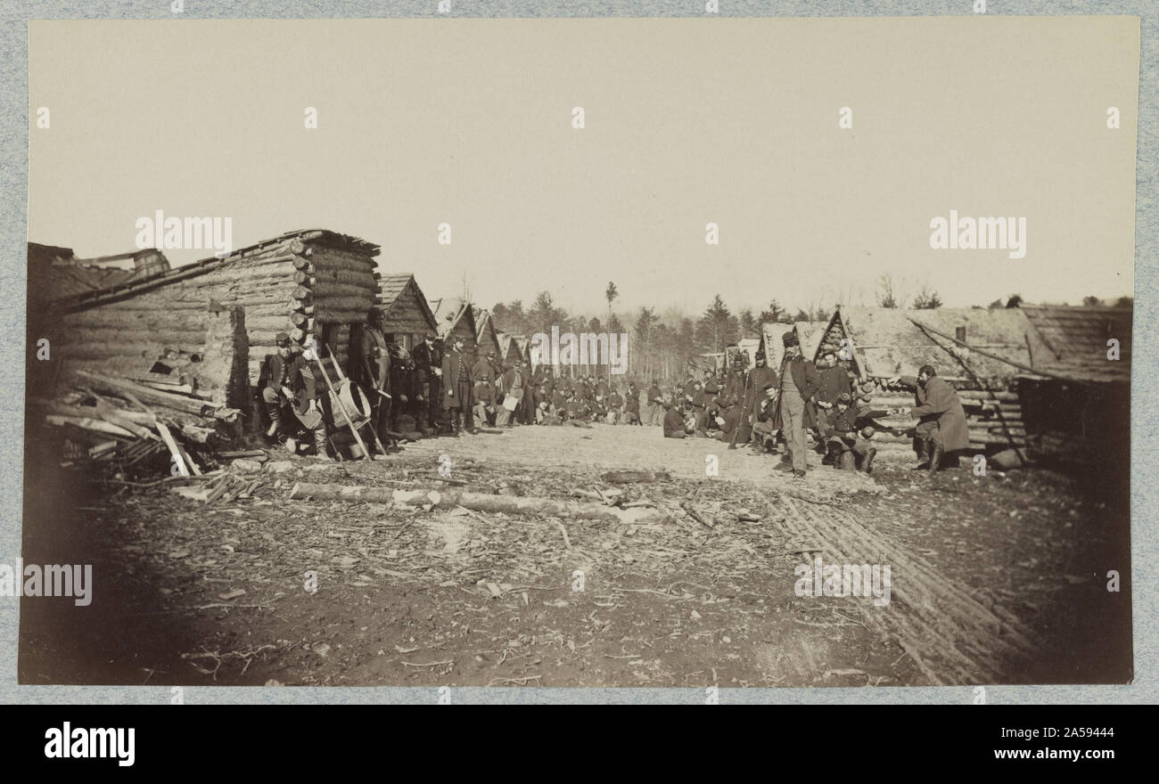 Union soldiers, in camp, posed in front of log buildings Stock Photo ...