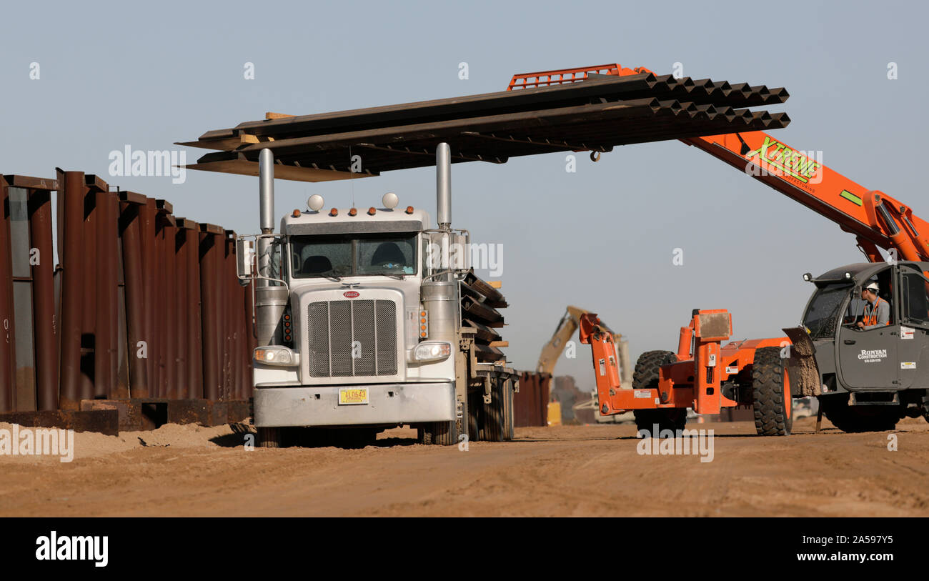 A lift unloads large, steel panels from a tractor-trailer that will ...
