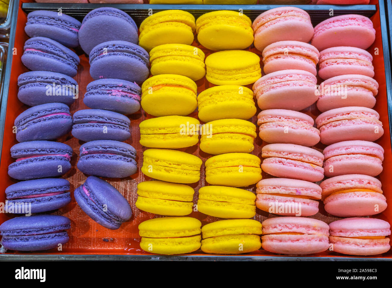 Colorful macaroon cakes in tray for sale at bakery Stock Photo - Alamy