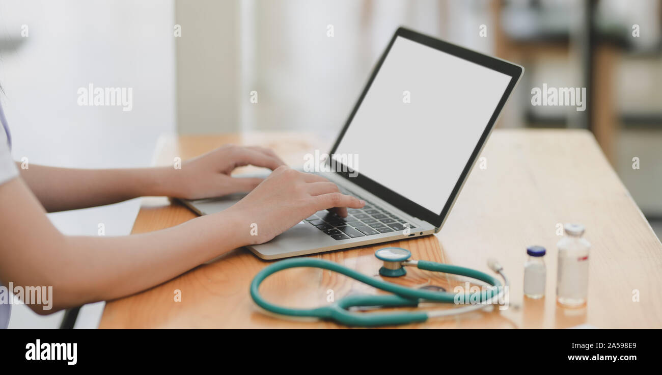 Close-up view of young female doctor examining the patient chart while ...