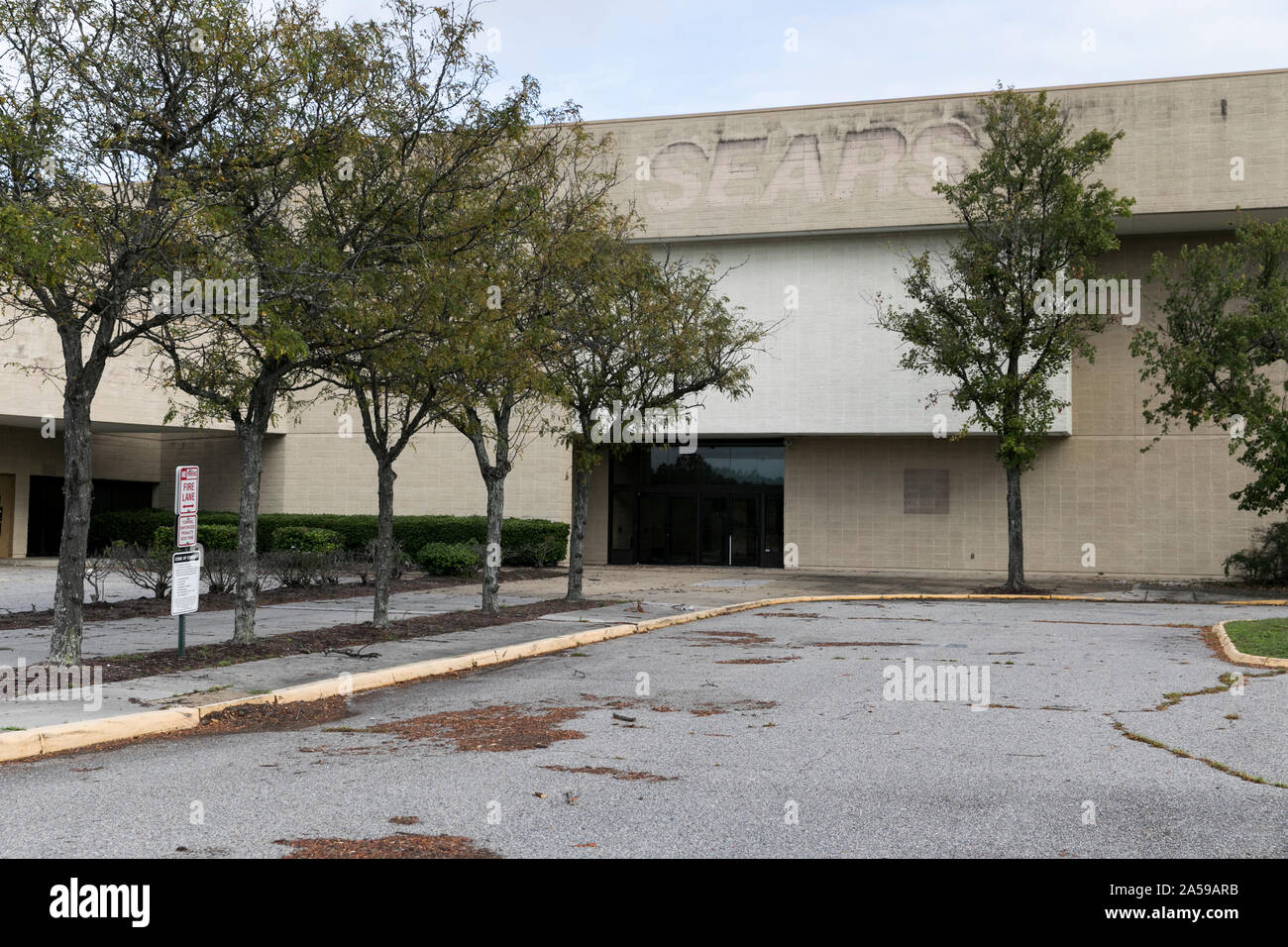 T The faded outline of a logo sign outside of a closed Sears retail ...