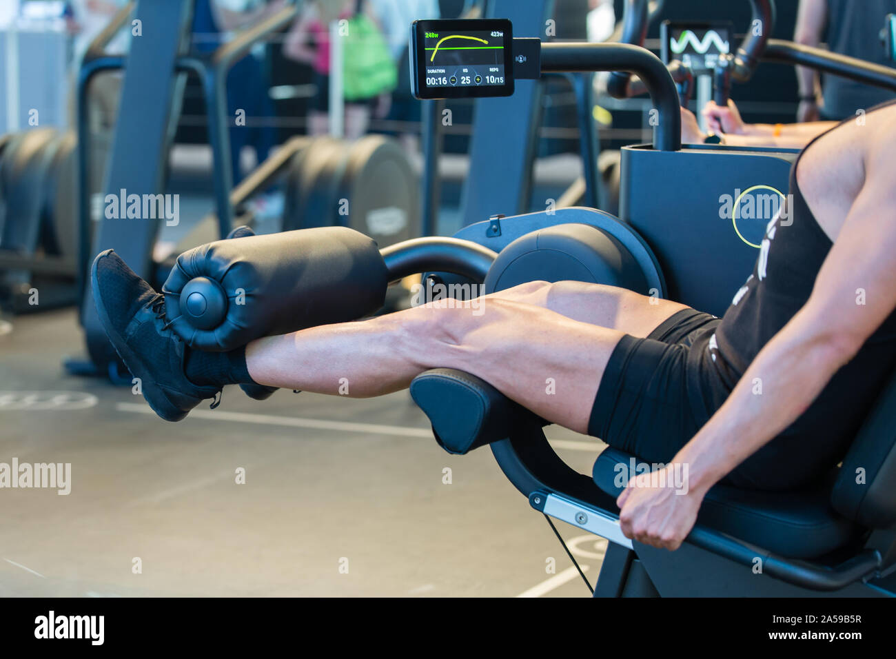 Professional Bodybuilder Doing Exercises at Gym: Leg Extensions Workout ...