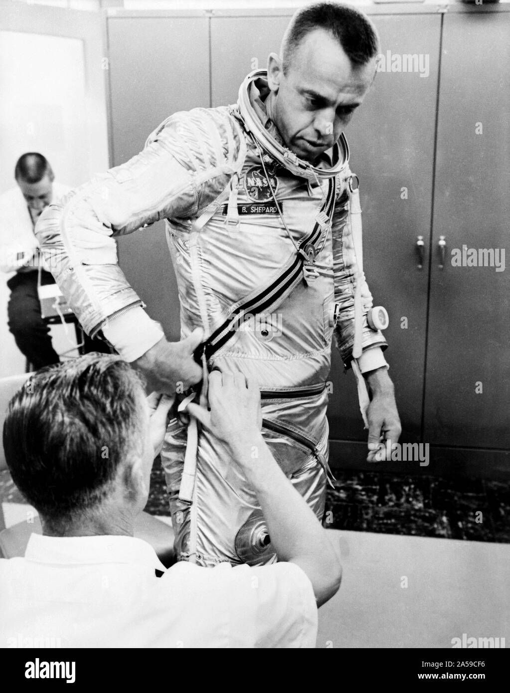 (5 May 1961) --- Astronaut Alan B. Shepard Jr. is being helped into his ...