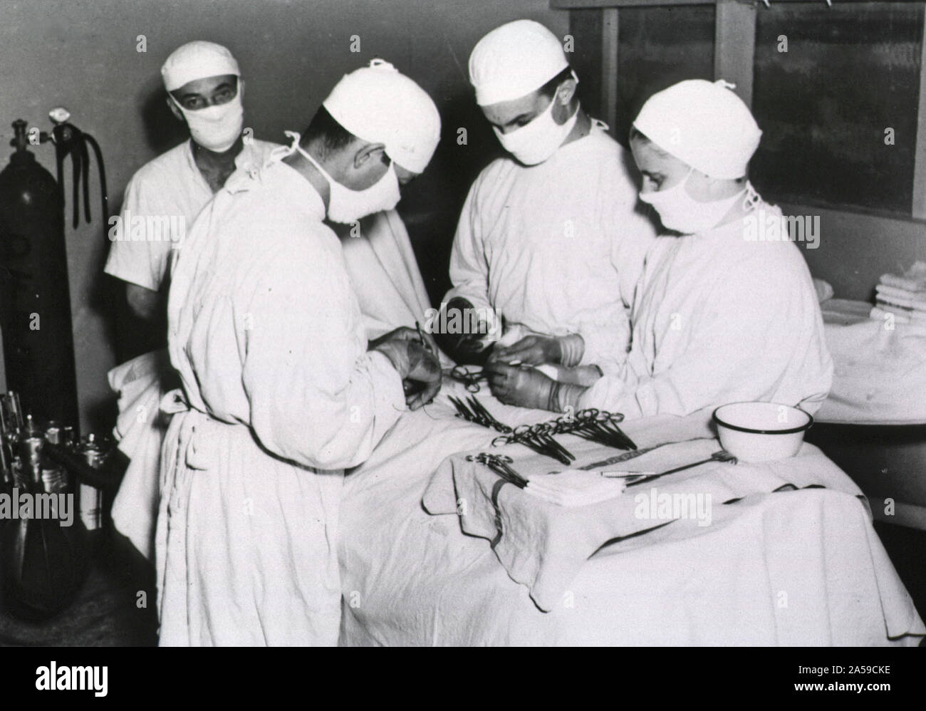 A surgeon, anesthetist, technician, and nurse participate in the ...