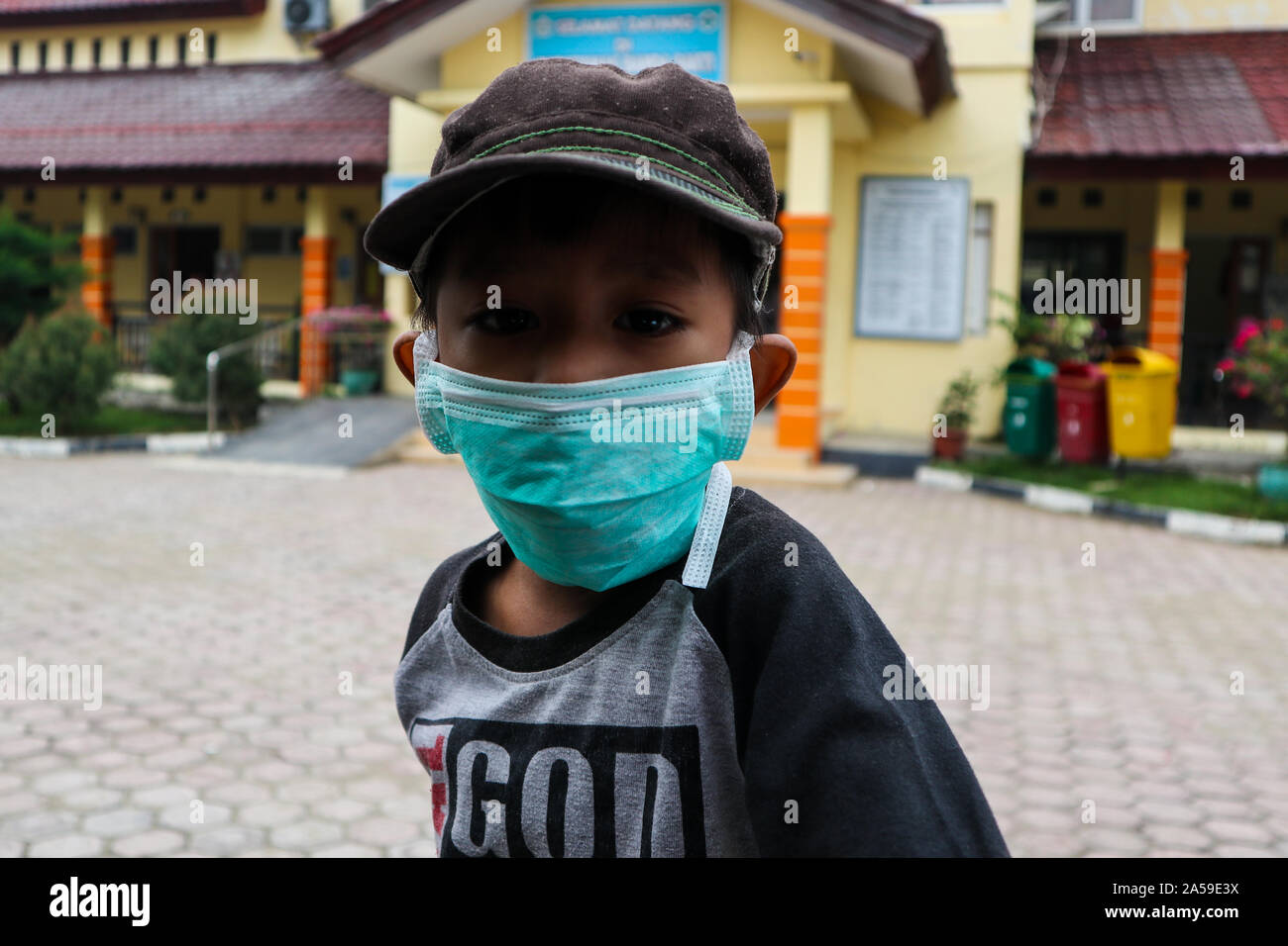A child wears a mask to avoid the haze caused by forest fires in ...