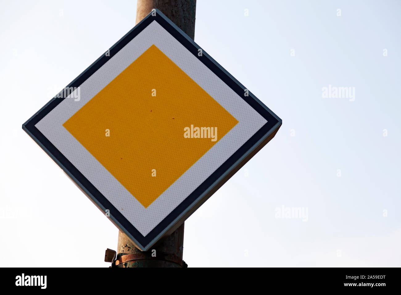 the traffic sign for the main road sits on a rusty lamp post Stock ...
