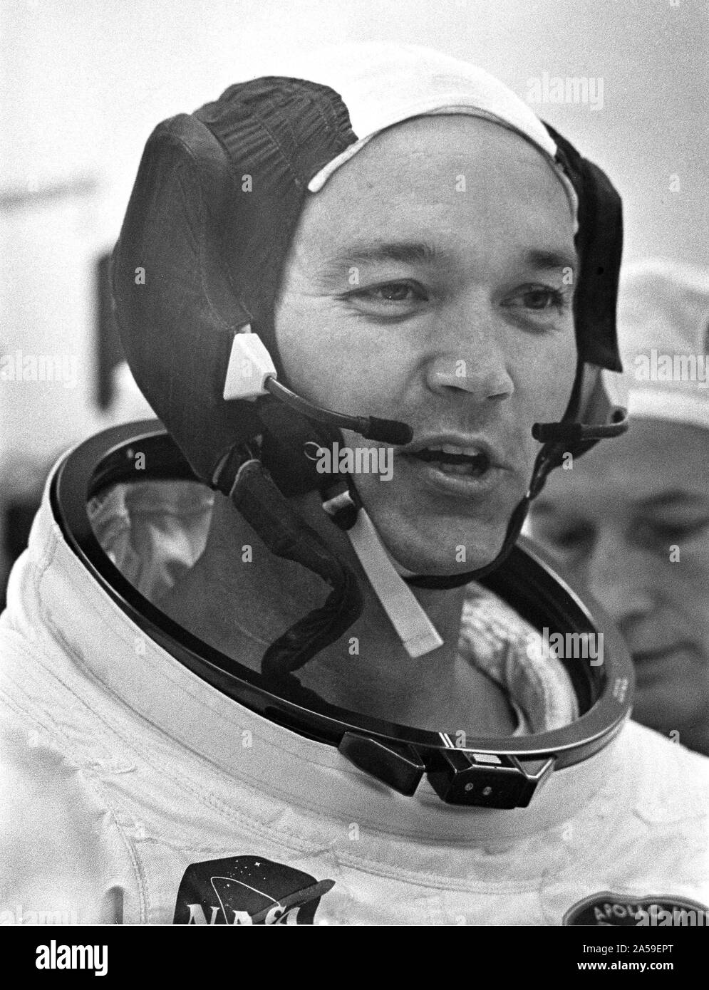 Dunned in his space suit, Command Module (CM) pilot Michael Collins ...