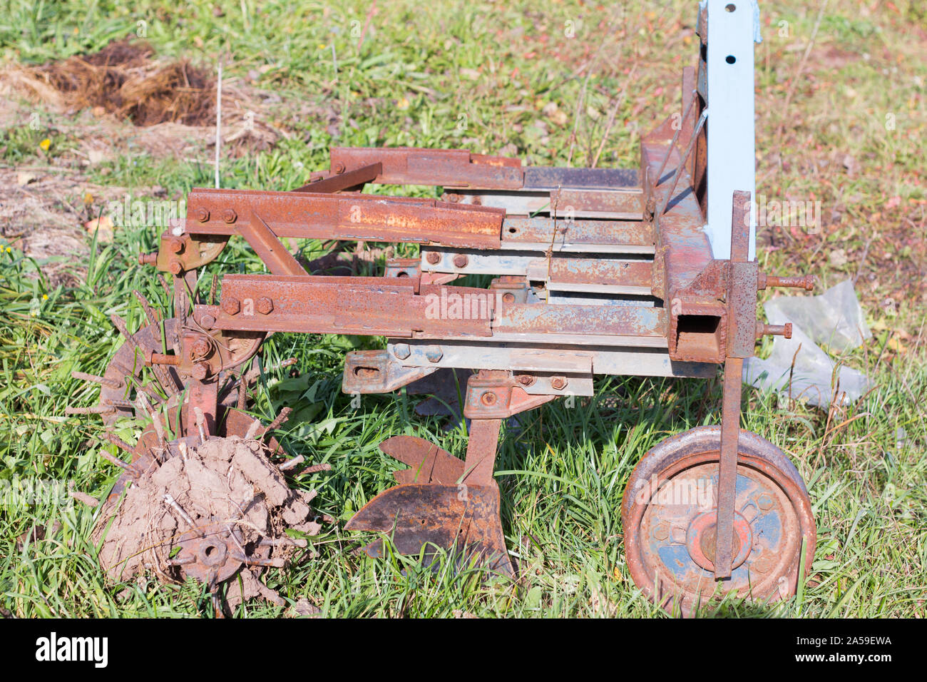 Agricultural tool, old rusty plow for tractor lying in the field Stock ...