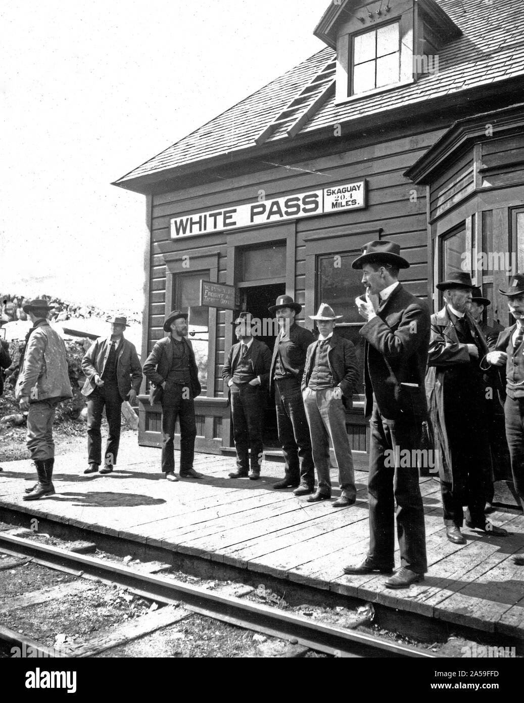photo from 1900 of gentleman and prospectors standing at the White Pass ...