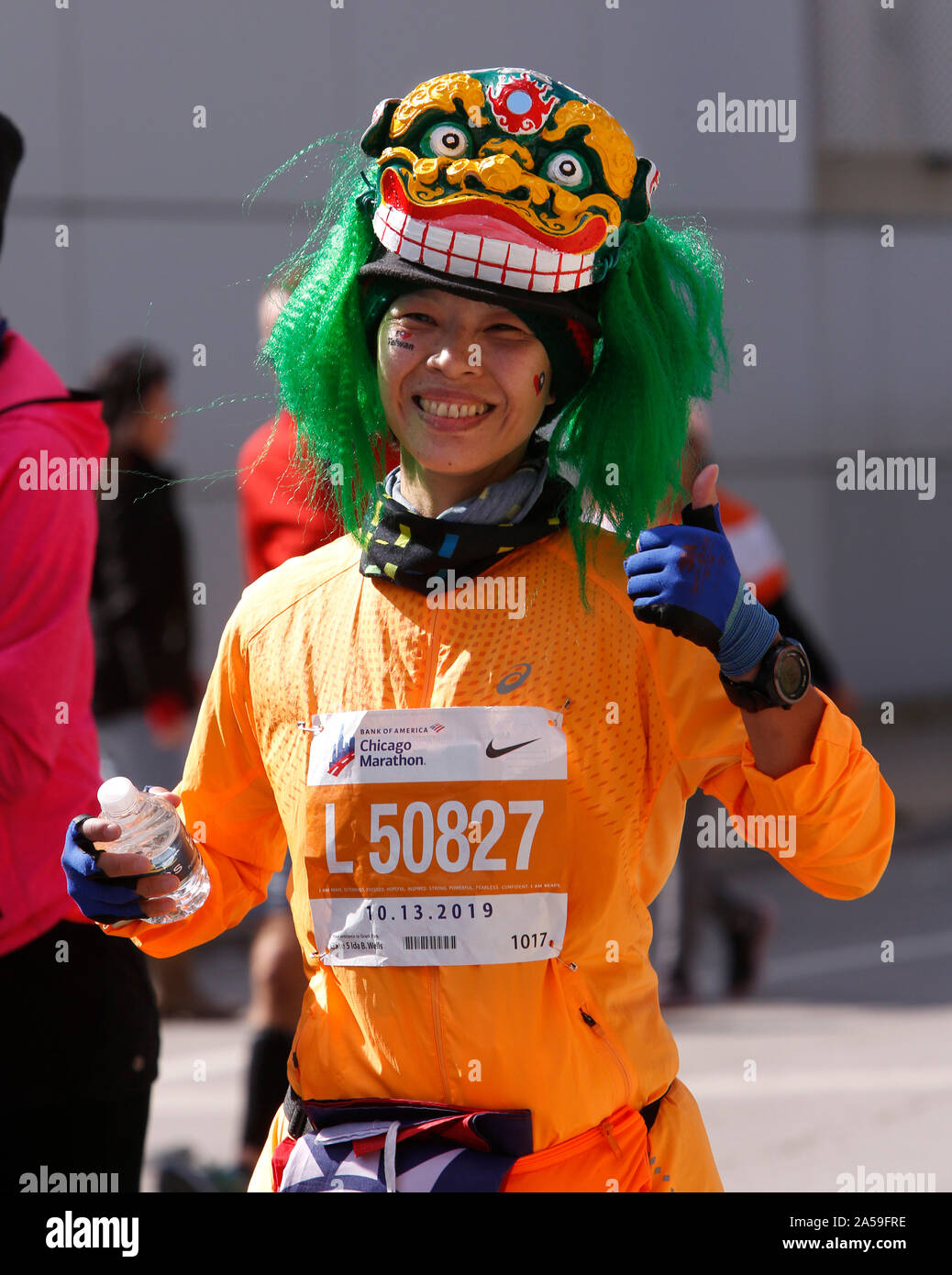 Hui Ling Lin from Taipei finishes the Marathon dressed as a dragon ...
