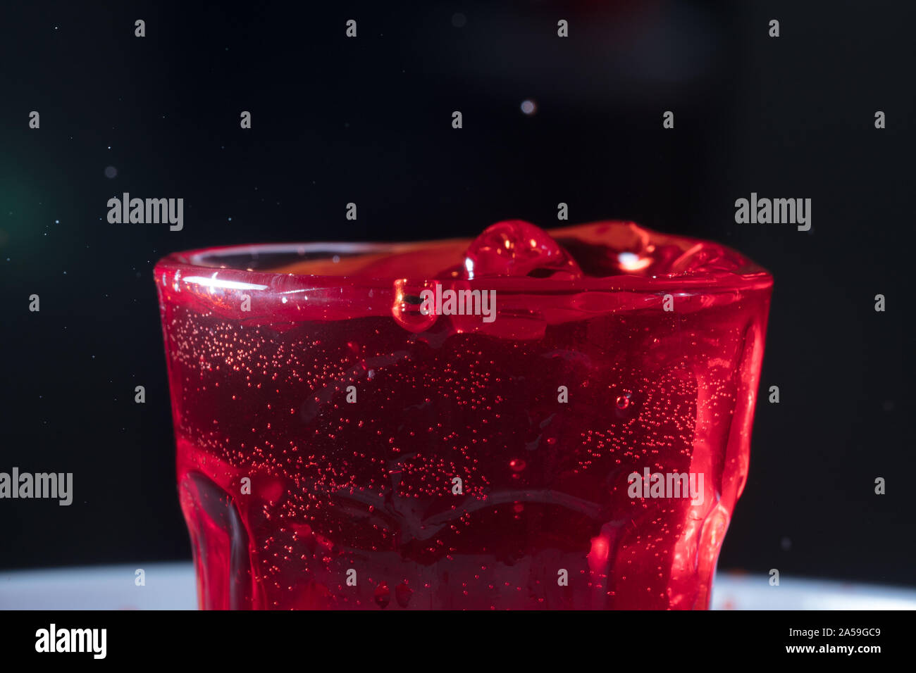 drops of red liquid in glass beaker Stock Photo - Alamy