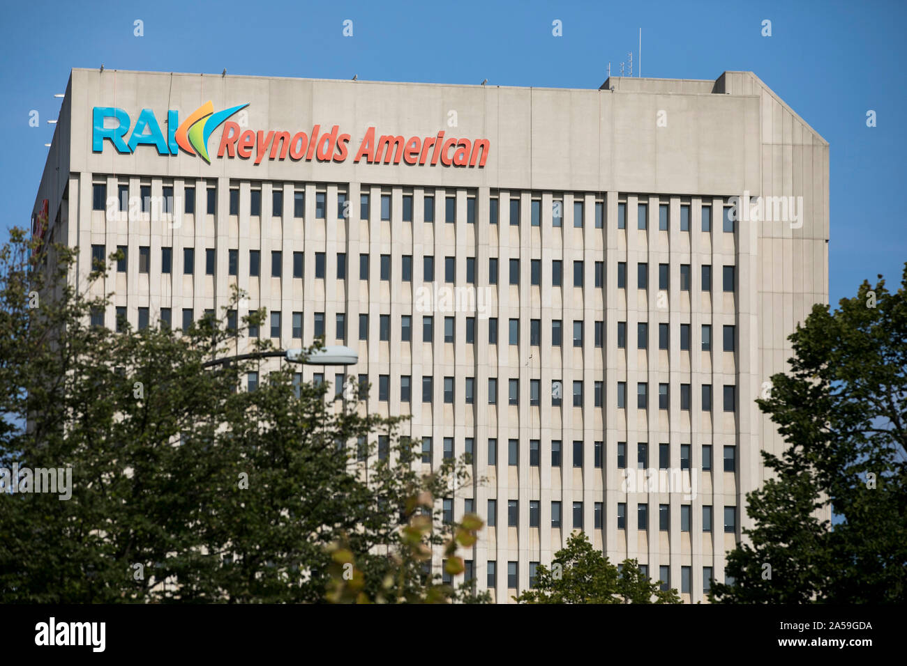 A logo sign outside of the headquarters of Reynolds American, Inc ...