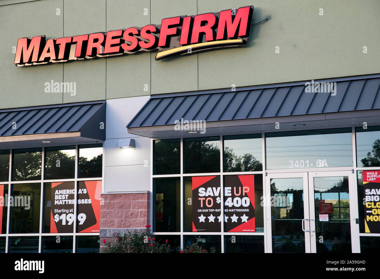 A logo sign outside of a Mattress Firm retail store location in Wilson ...
