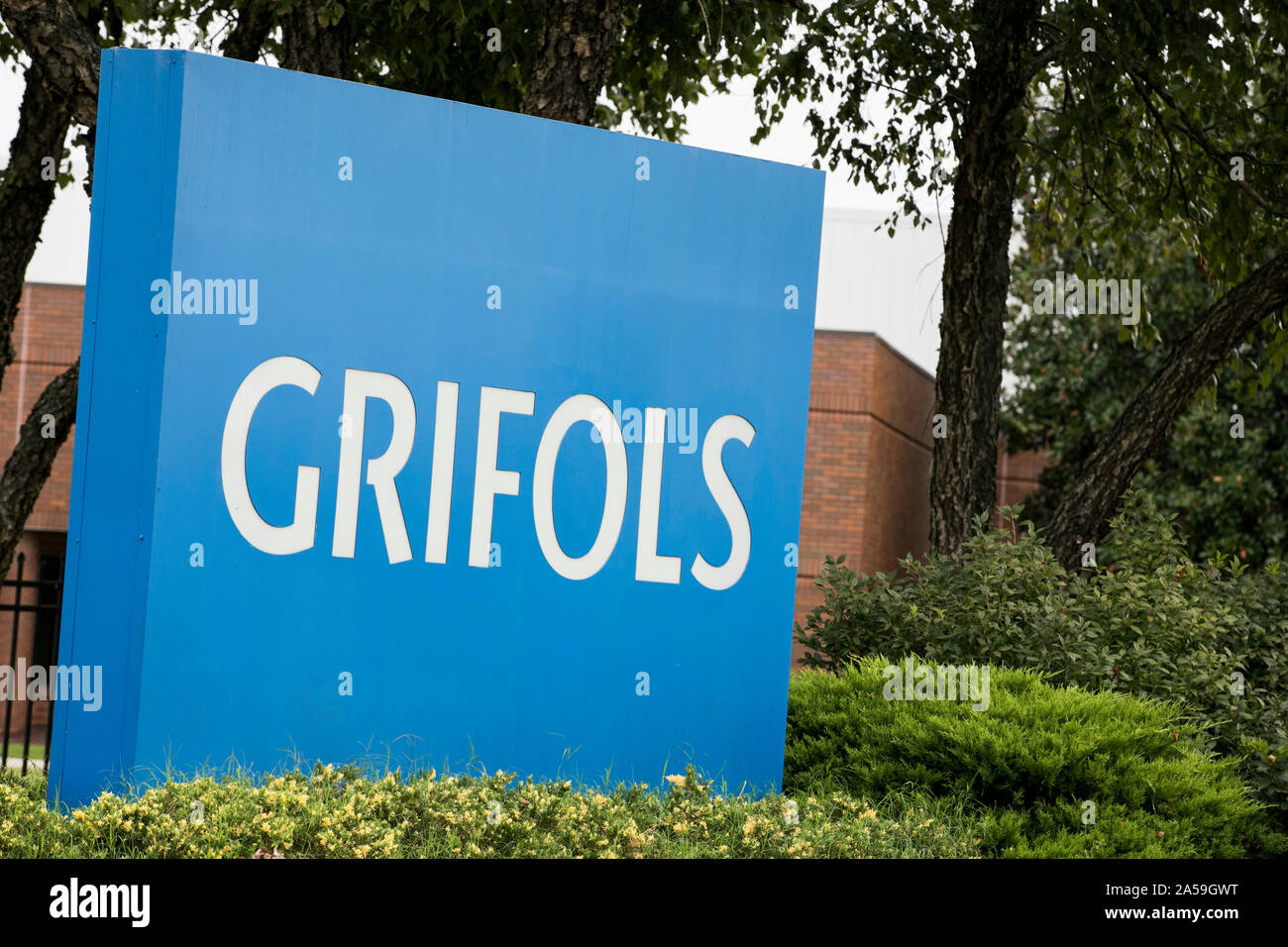 A logo sign outside of a facility occupied by Grifols in Clayton, North ...