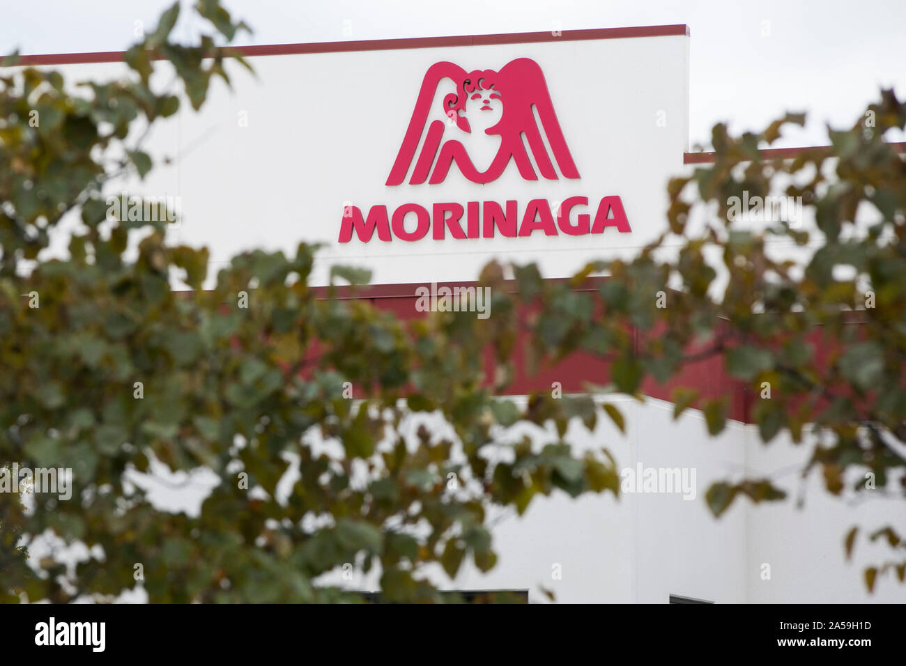 A logo sign outside of a facility occupied by Morinaga & Company in ...