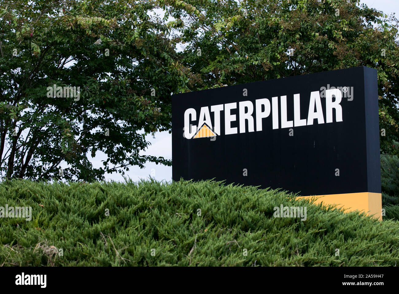 A logo sign outside of a facility occupied by Caterpillar, Inc., in ...