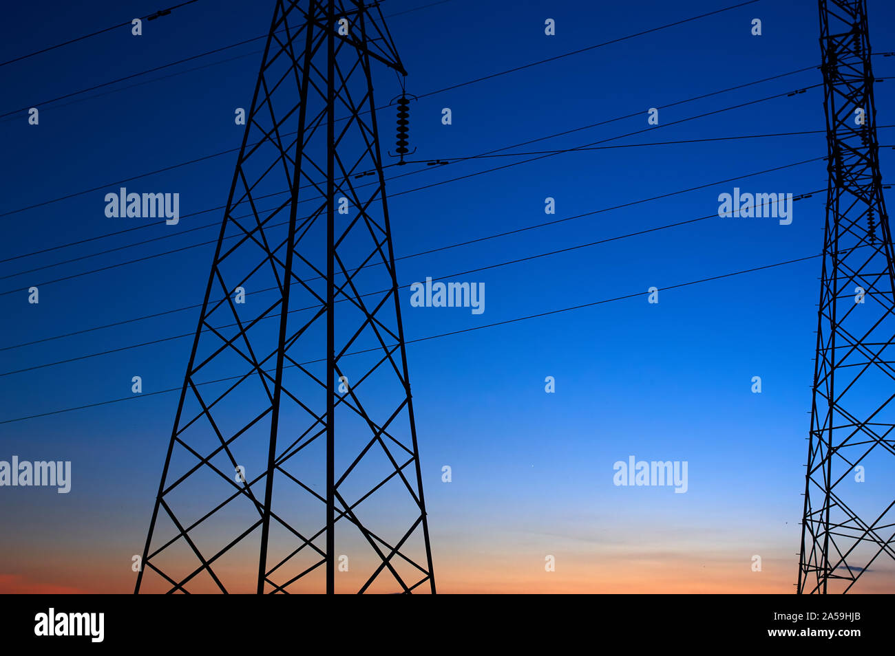 Electric pylon structure and dusk sky Stock Photo - Alamy