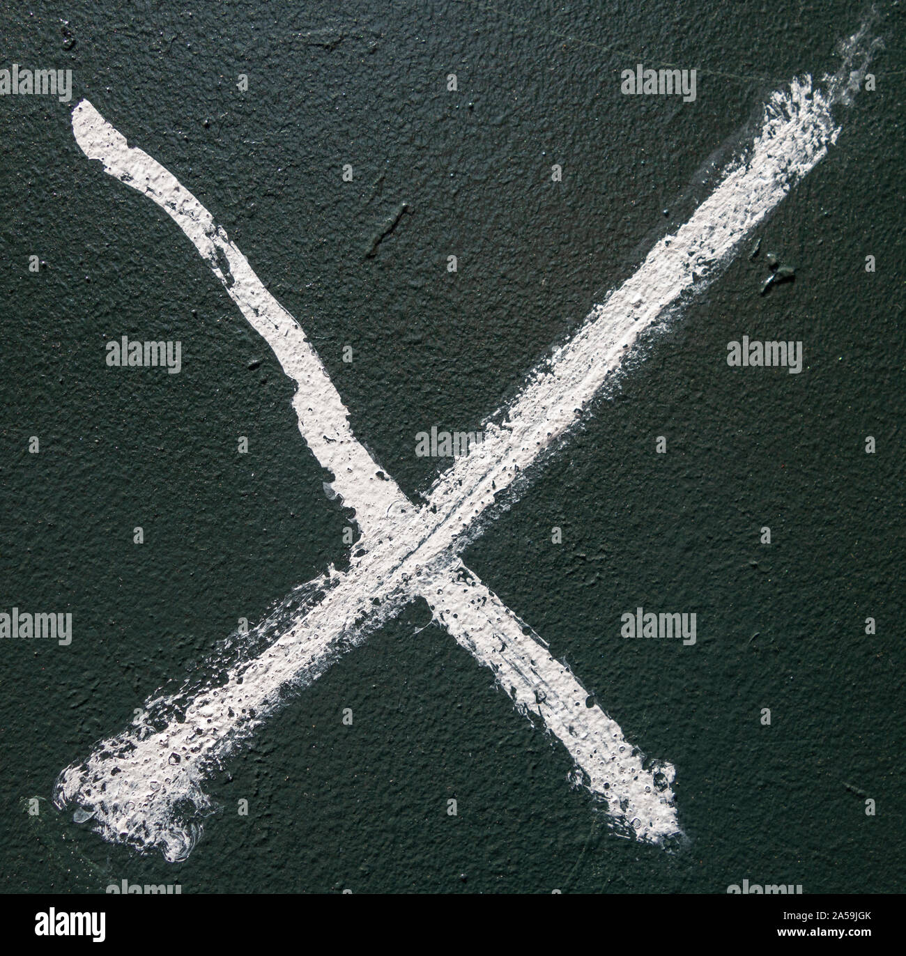 white brush on x on a green wall Stock Photo - Alamy