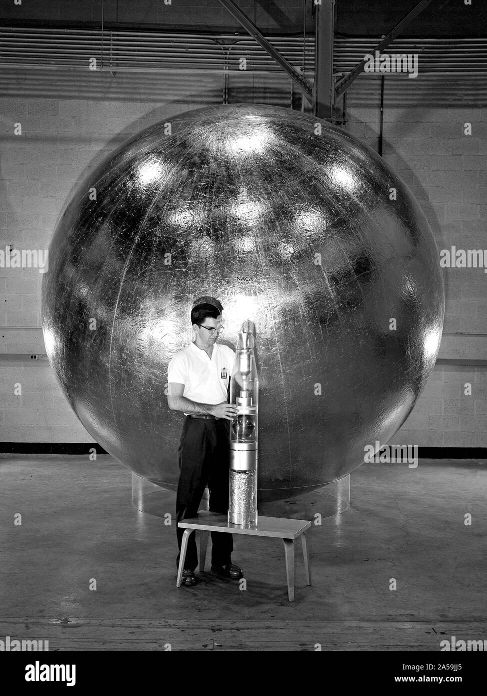Engineer and 12 foot Beacon showing NACA emblem on inflated satelloon ...