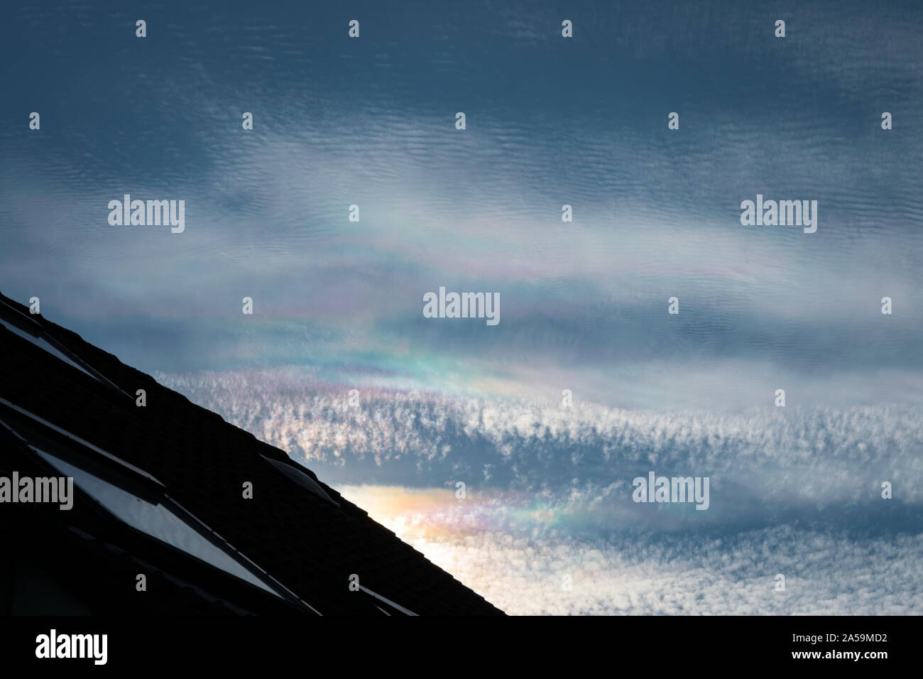 Iridescent clouds. Iridescence close to the sun in thin altocumulus and ...