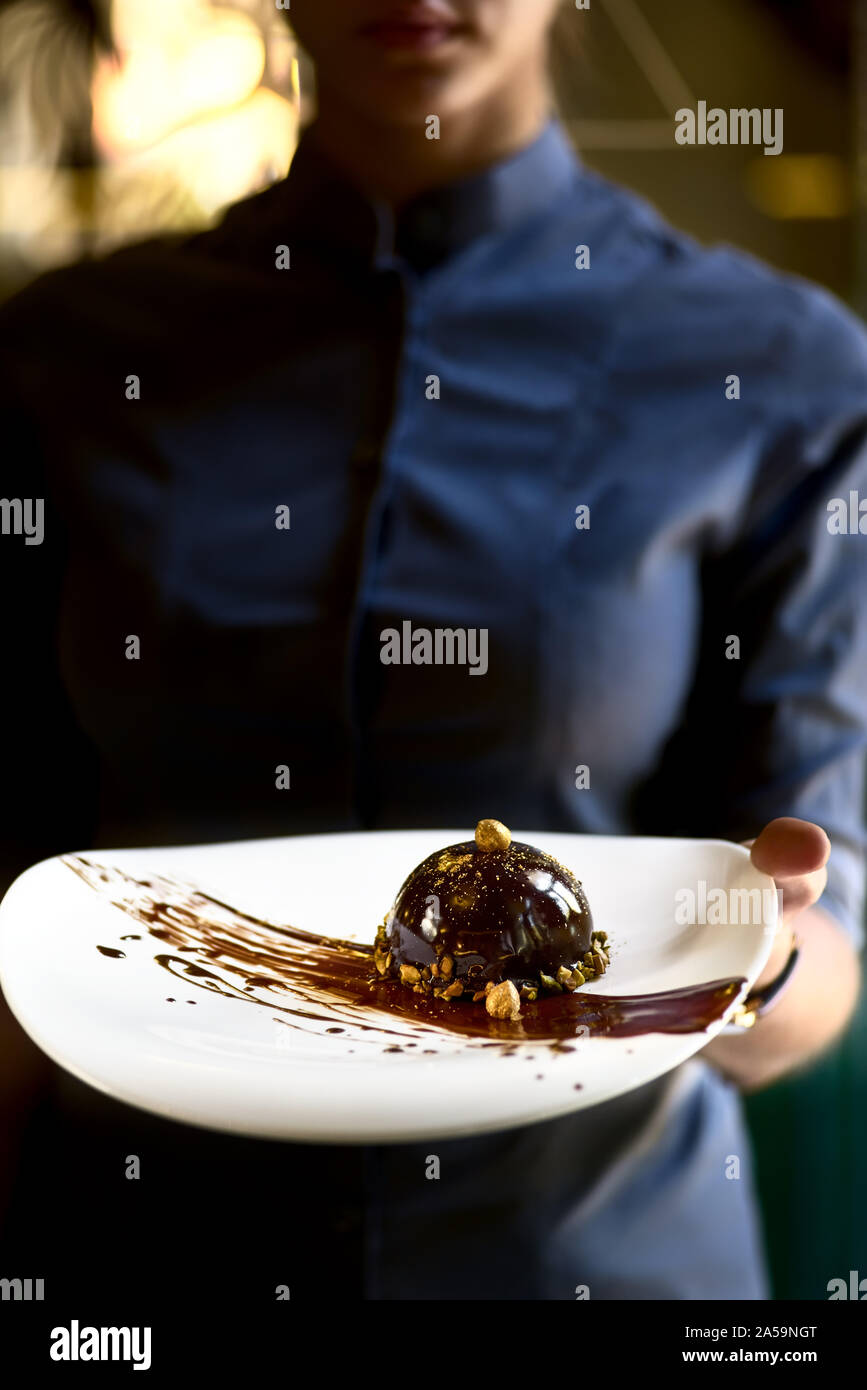 French mini mousse pastry dessert in chocolate icing on a plate ...