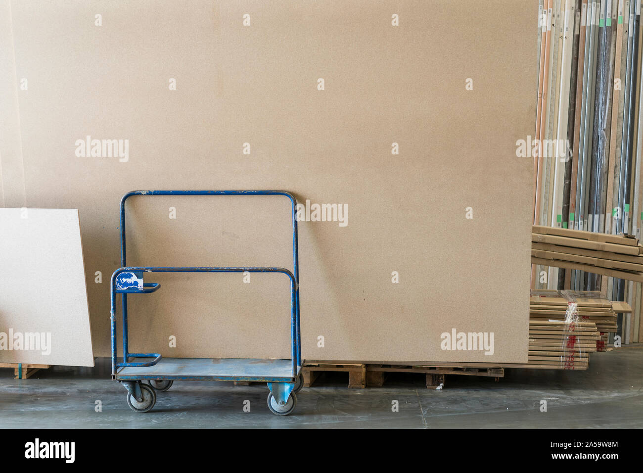 Trolley in a hardware store with building materials. Warehouse large ...