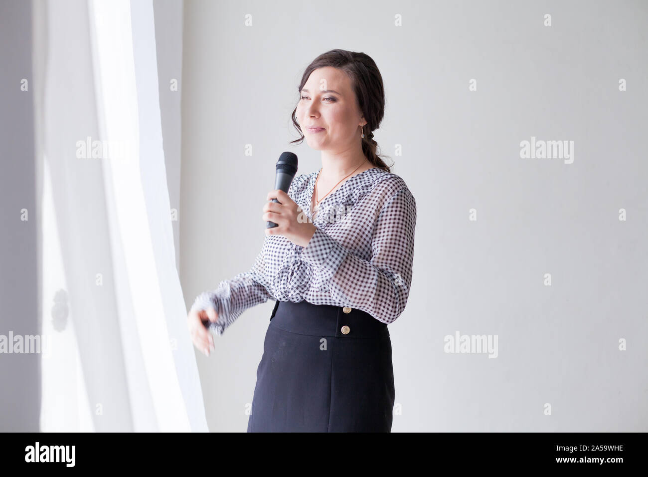 Asian woman talks into microphone sings nice Stock Photo - Alamy Asian woman talks into microphone sings nice Stock Photo - Alamy
