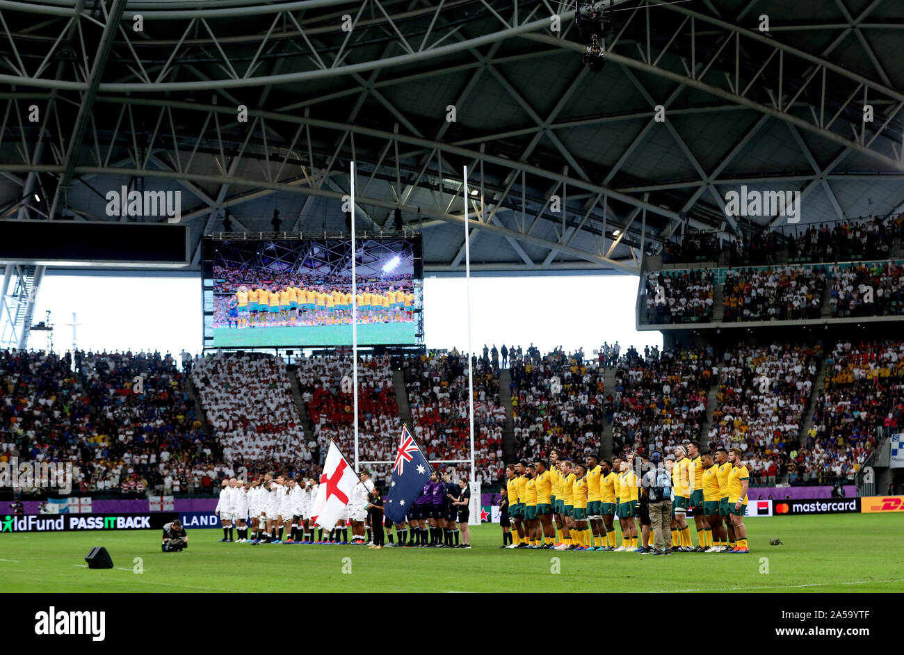 England players and Australia players line up on the pitch prior to the ...