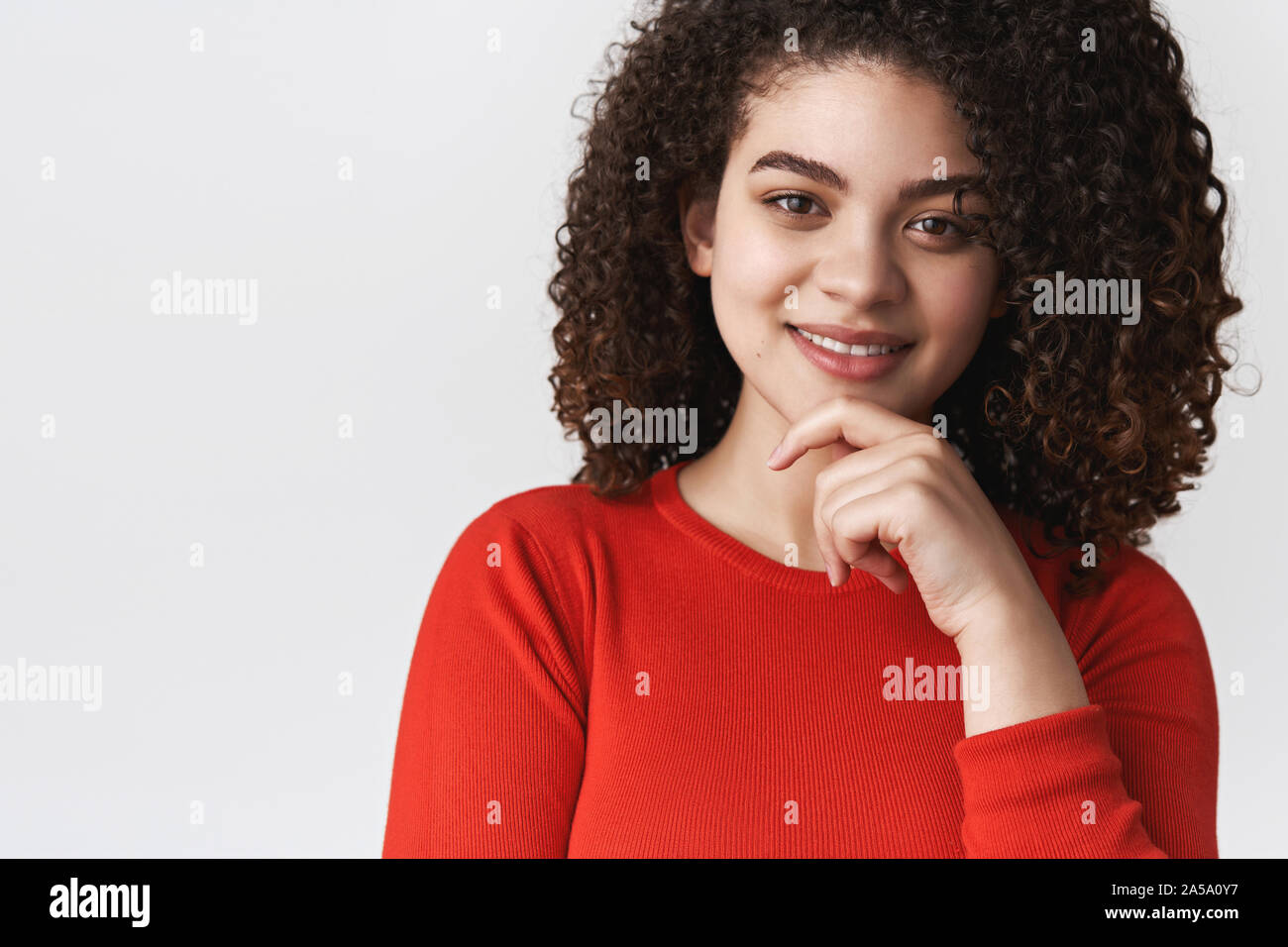 Close-up smart curious good-looking clever woman dark curly hairstyle ...