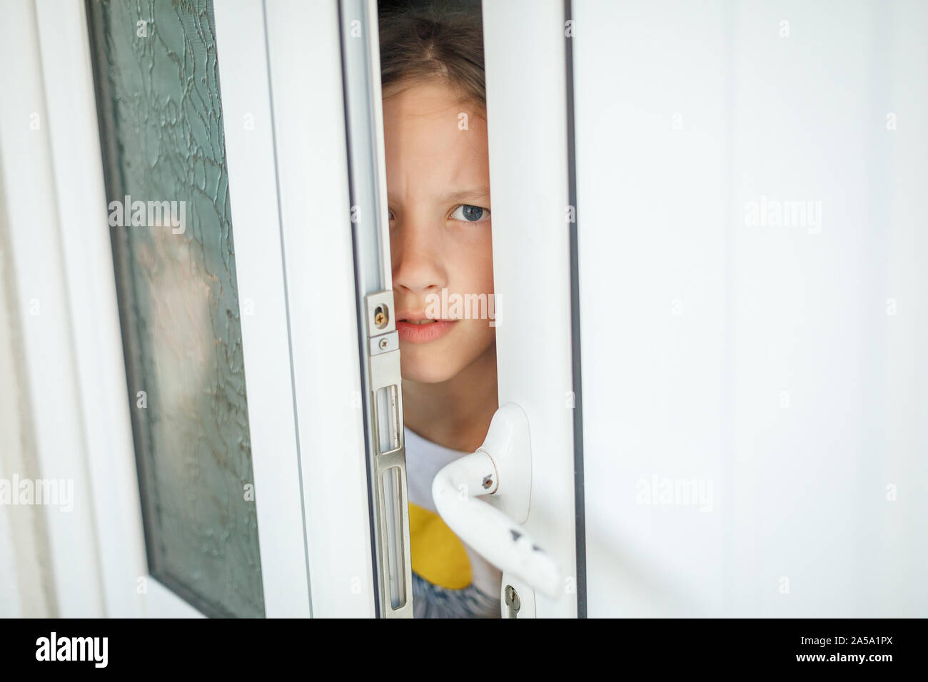 Girl kid in opened door. Safety abstract concept Stock Photo - Alamy