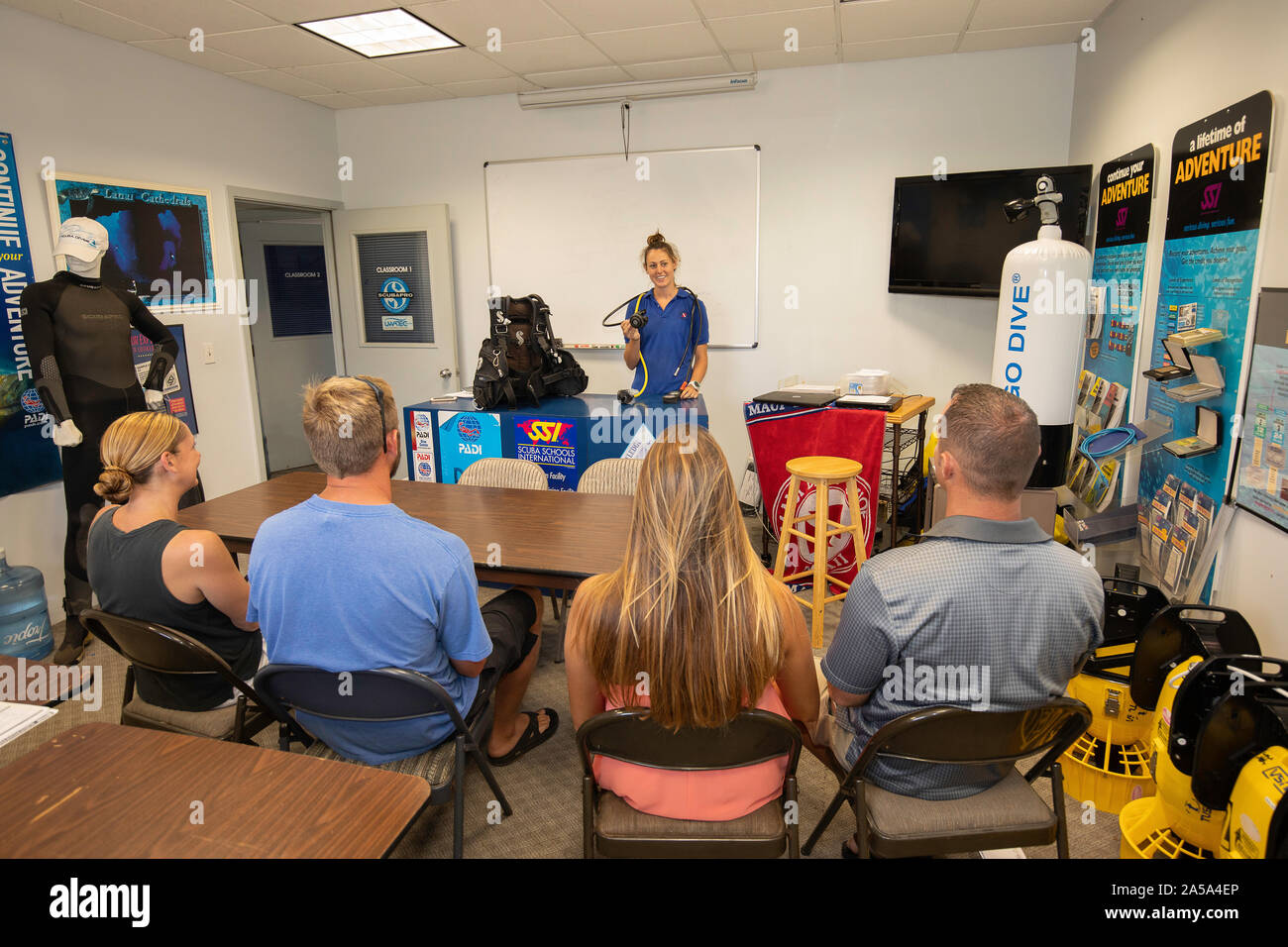 SCUBA diving instructor Danielle Miskinis explains equipment to four ...