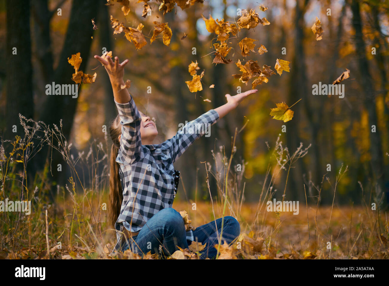 a young girl enjoying fall Stock Photo - Alamy