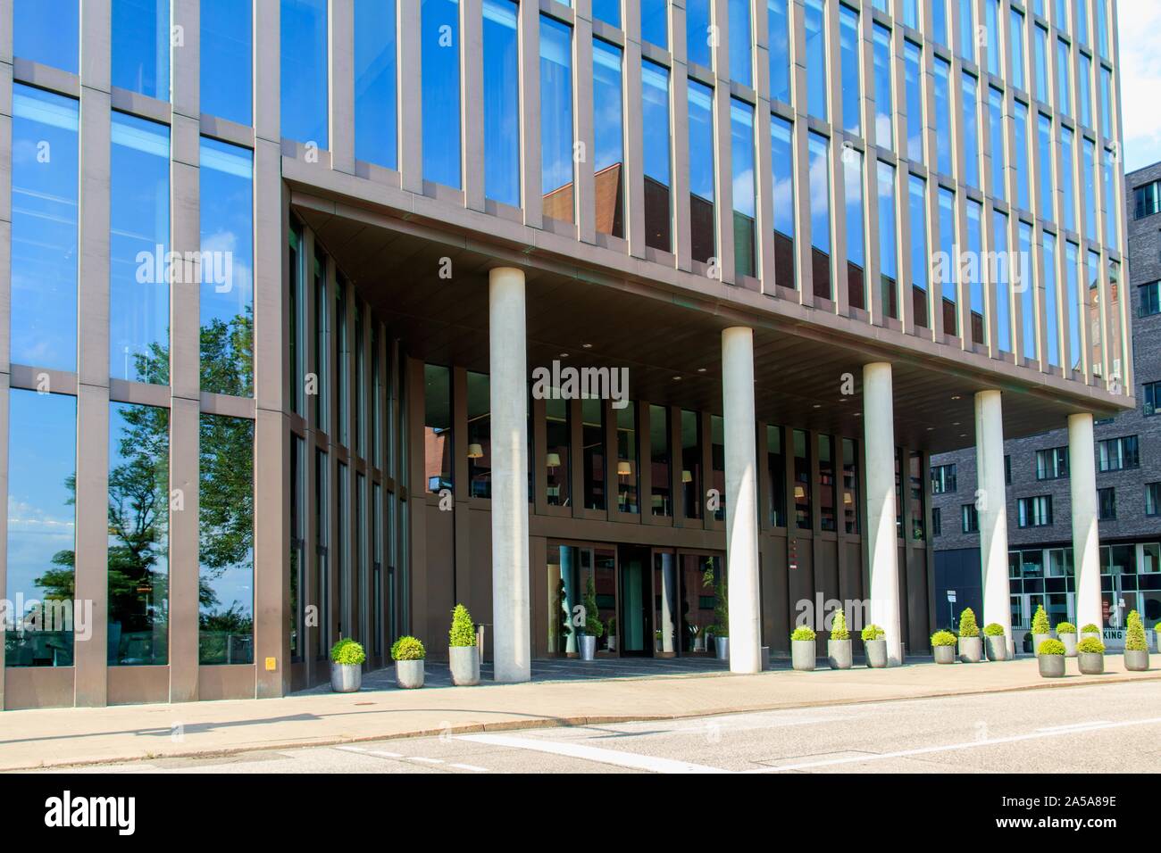 Vertical shot of a high-rise building with mirror windows under the ...