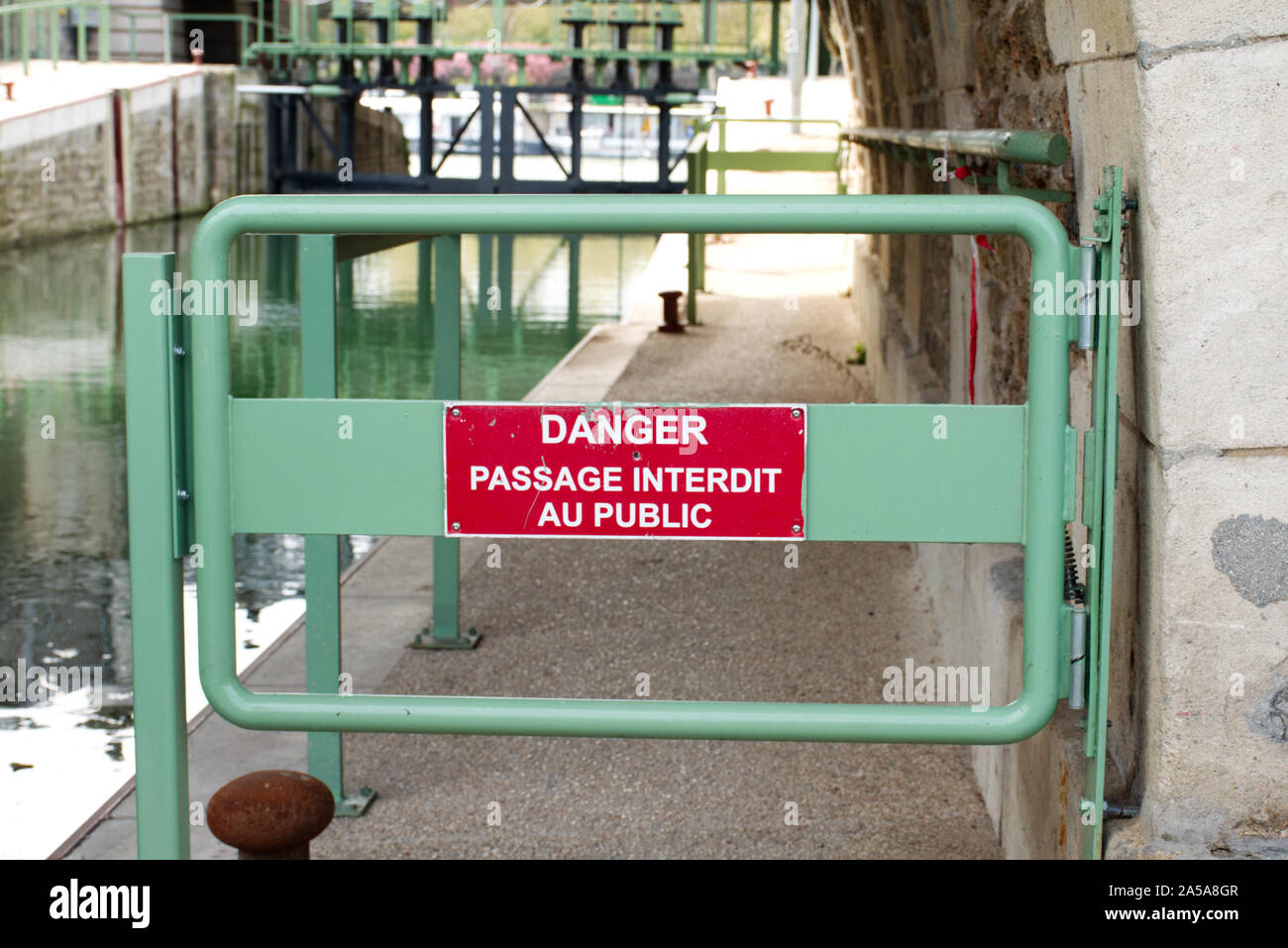 Close-up of a warning sign on a green gate, in Paris-France, near a ...