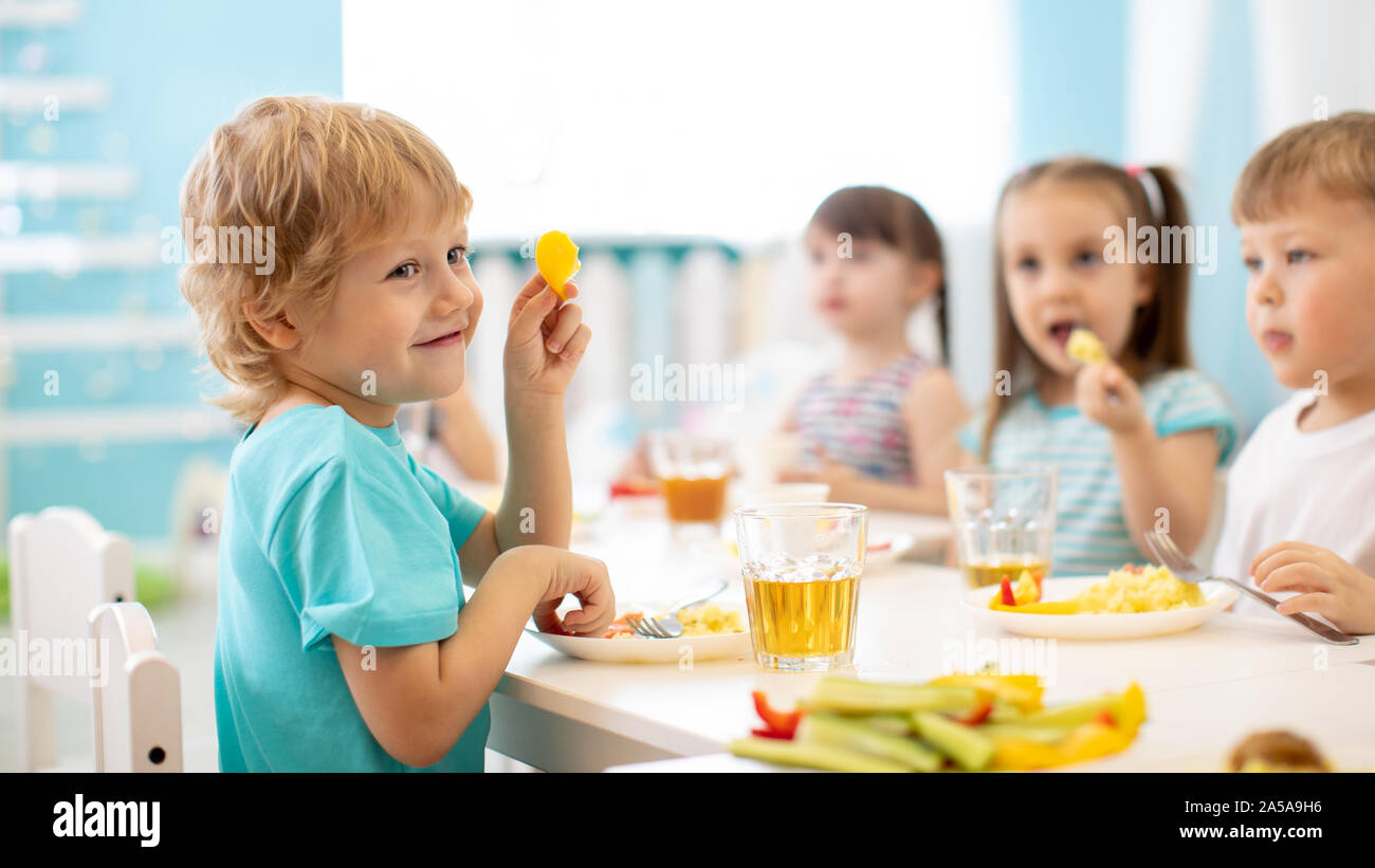 children eating healthy food in kindergarten or daycare Stock Photo - Alamy