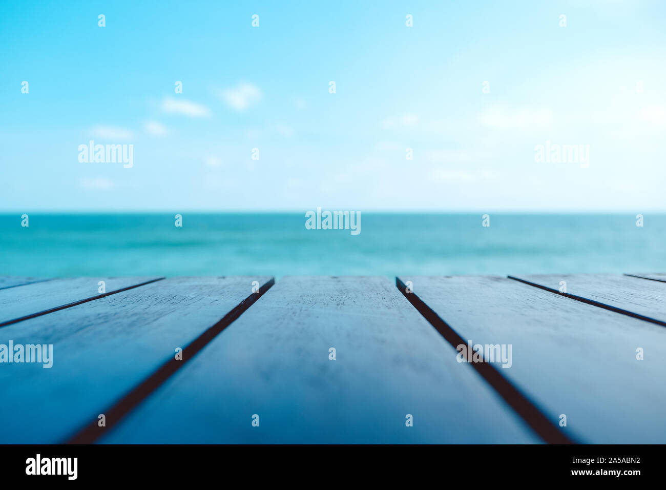 Wooden table with the sea and blue sky background Stock Photo - Alamy