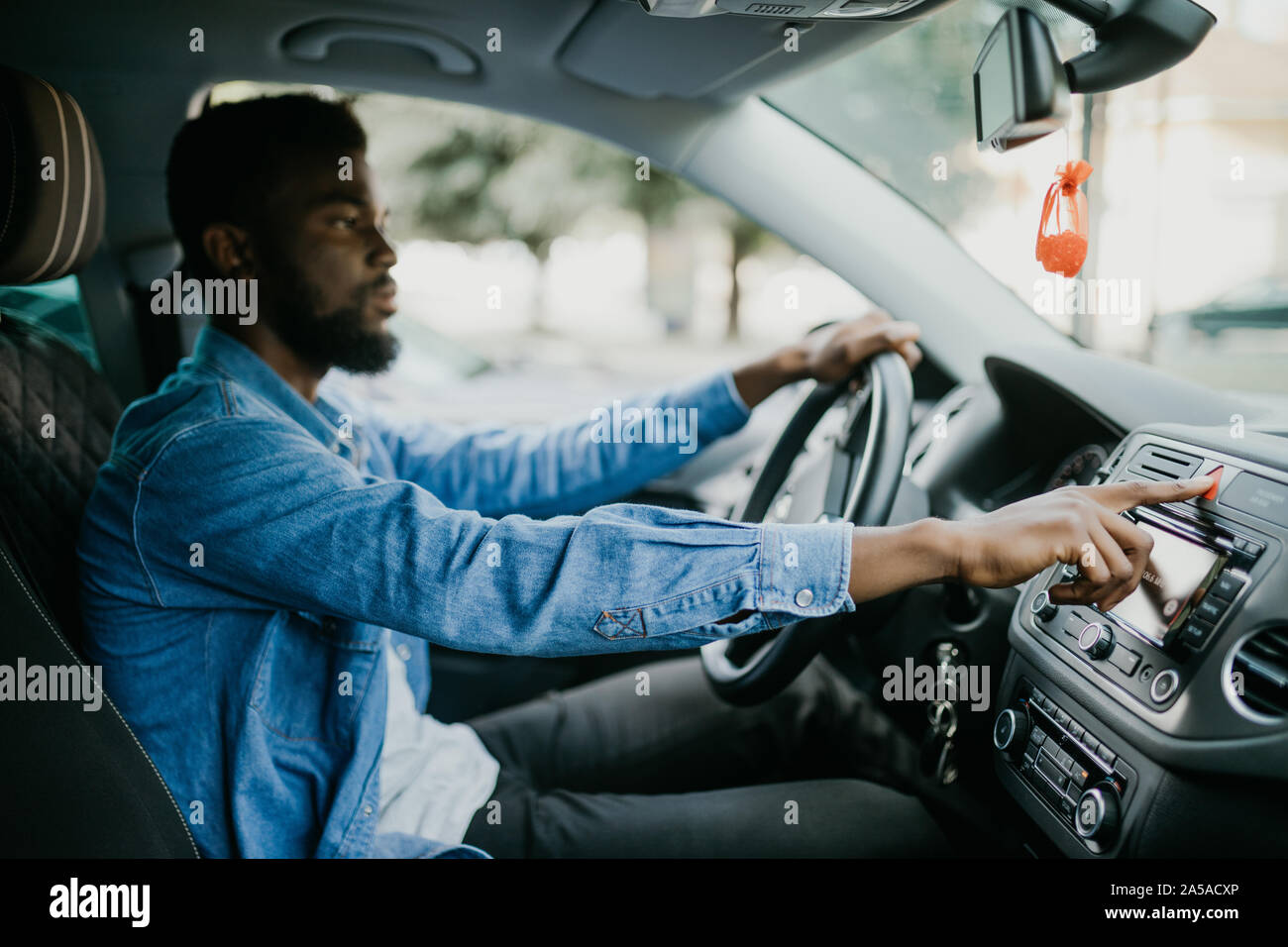 Young african handsome man push emergance button in the car while ...