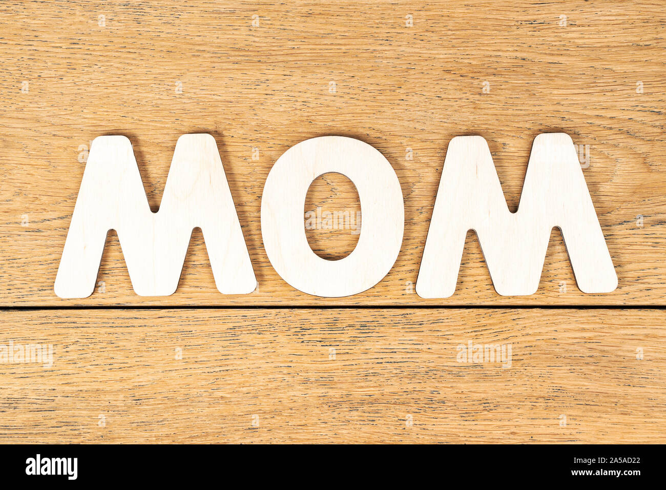 Word - mom, laid out letters on an old wooden oak table Stock Photo - Alamy