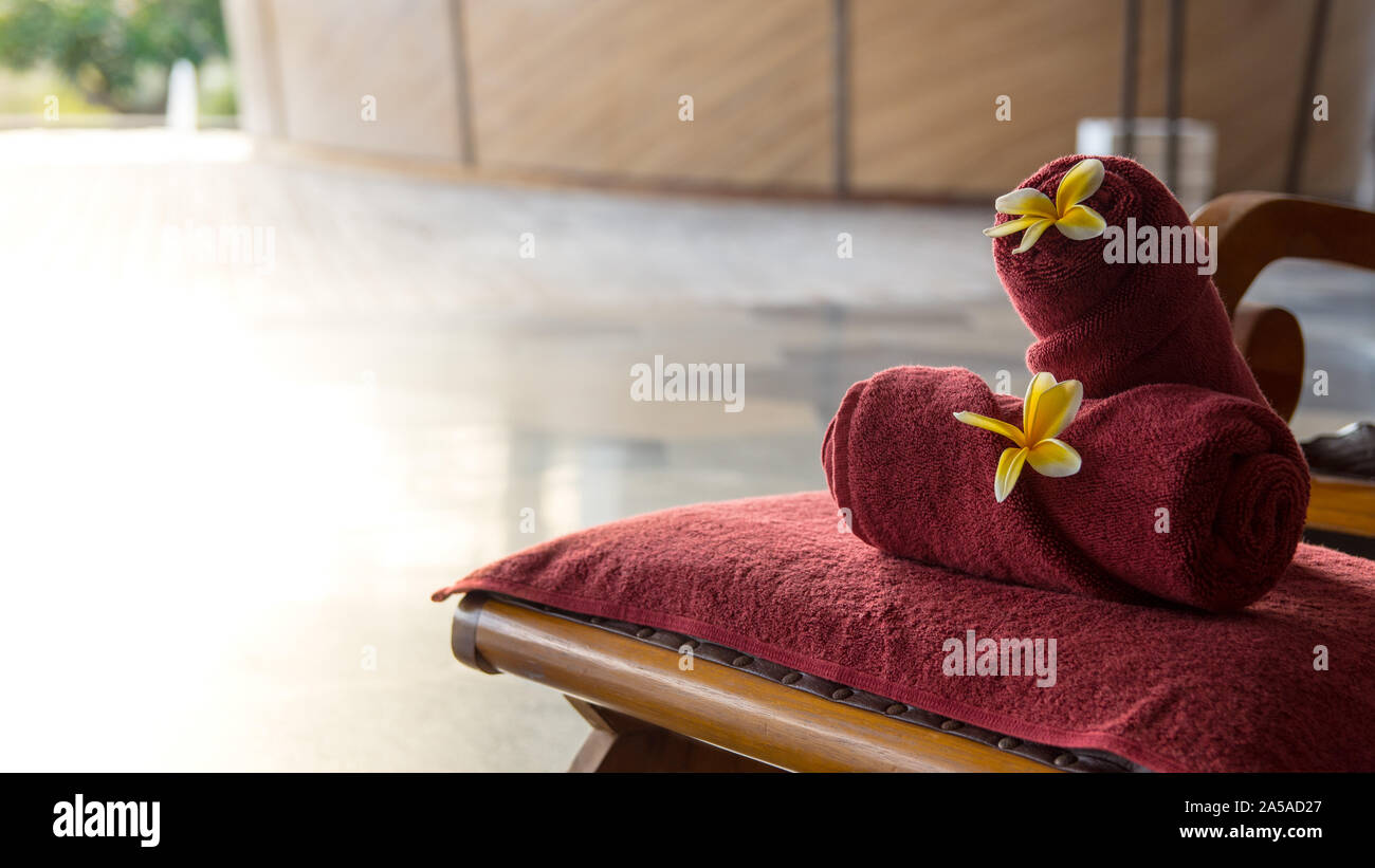 Towel and flowers on chair at resort spa - travel, vaction and ...