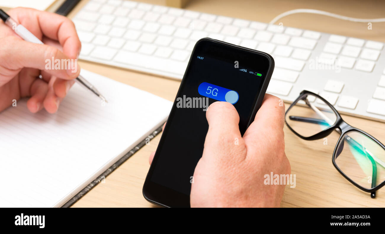 A 5G "wireless technology" button on smart phone device being turned on ...