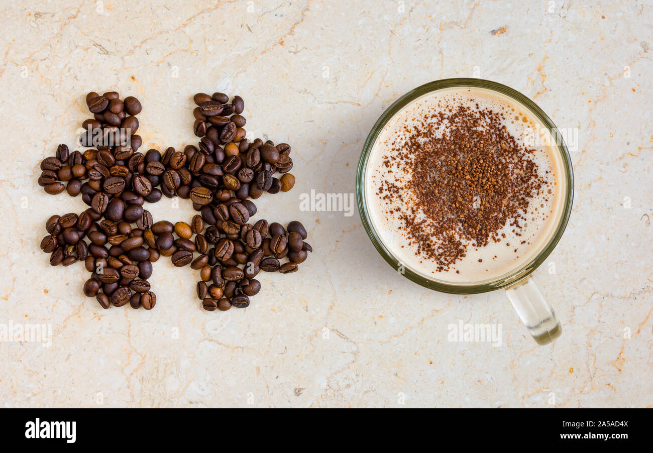 Hash tag icon symbol made from roasted coffee beans on marble surface ...
