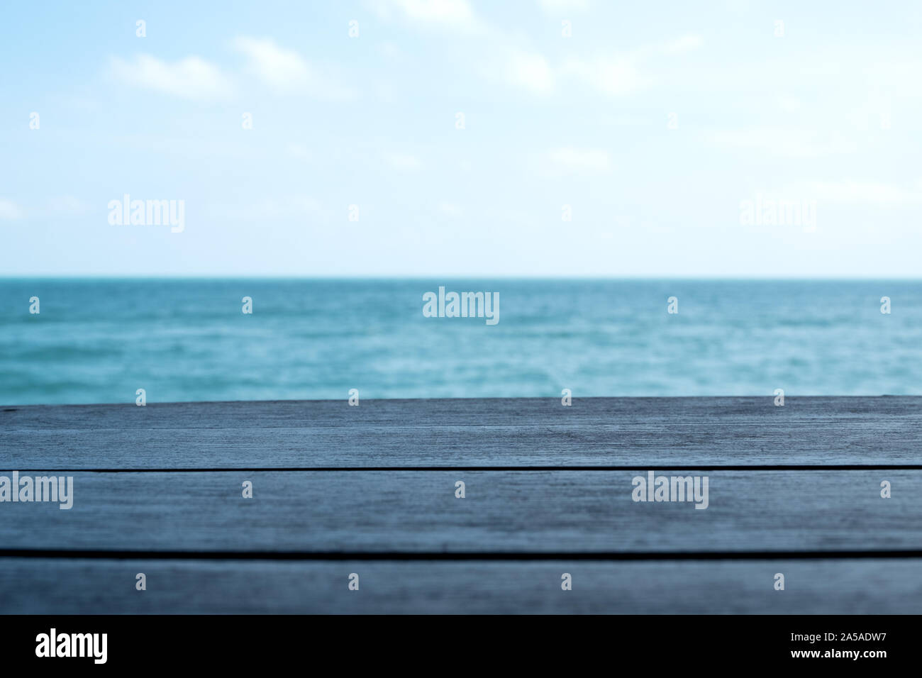 Wooden table with the sea and blue sky background Stock Photo - Alamy