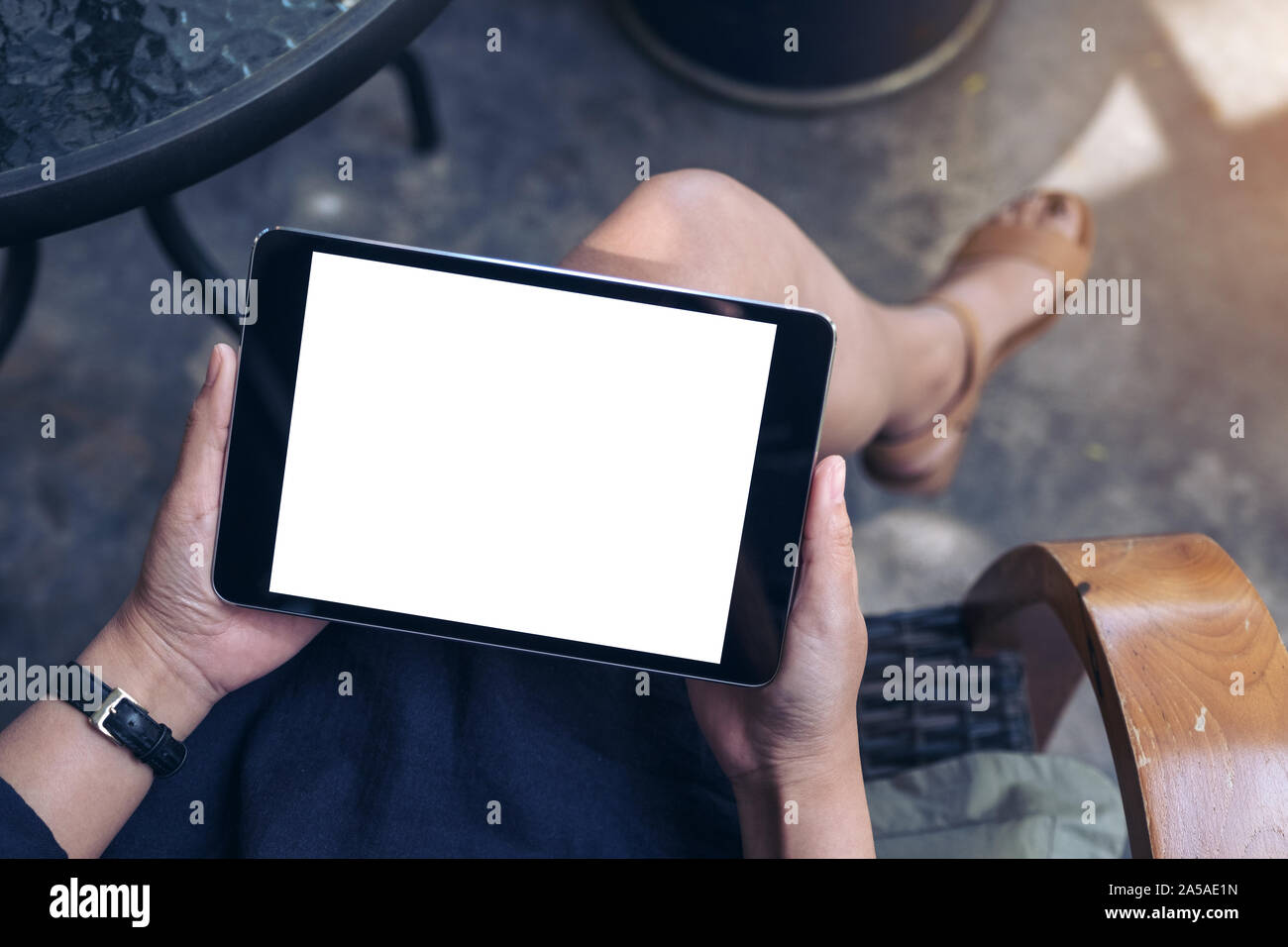 Top view mockup image of a woman sitting crossed legs holding black ...