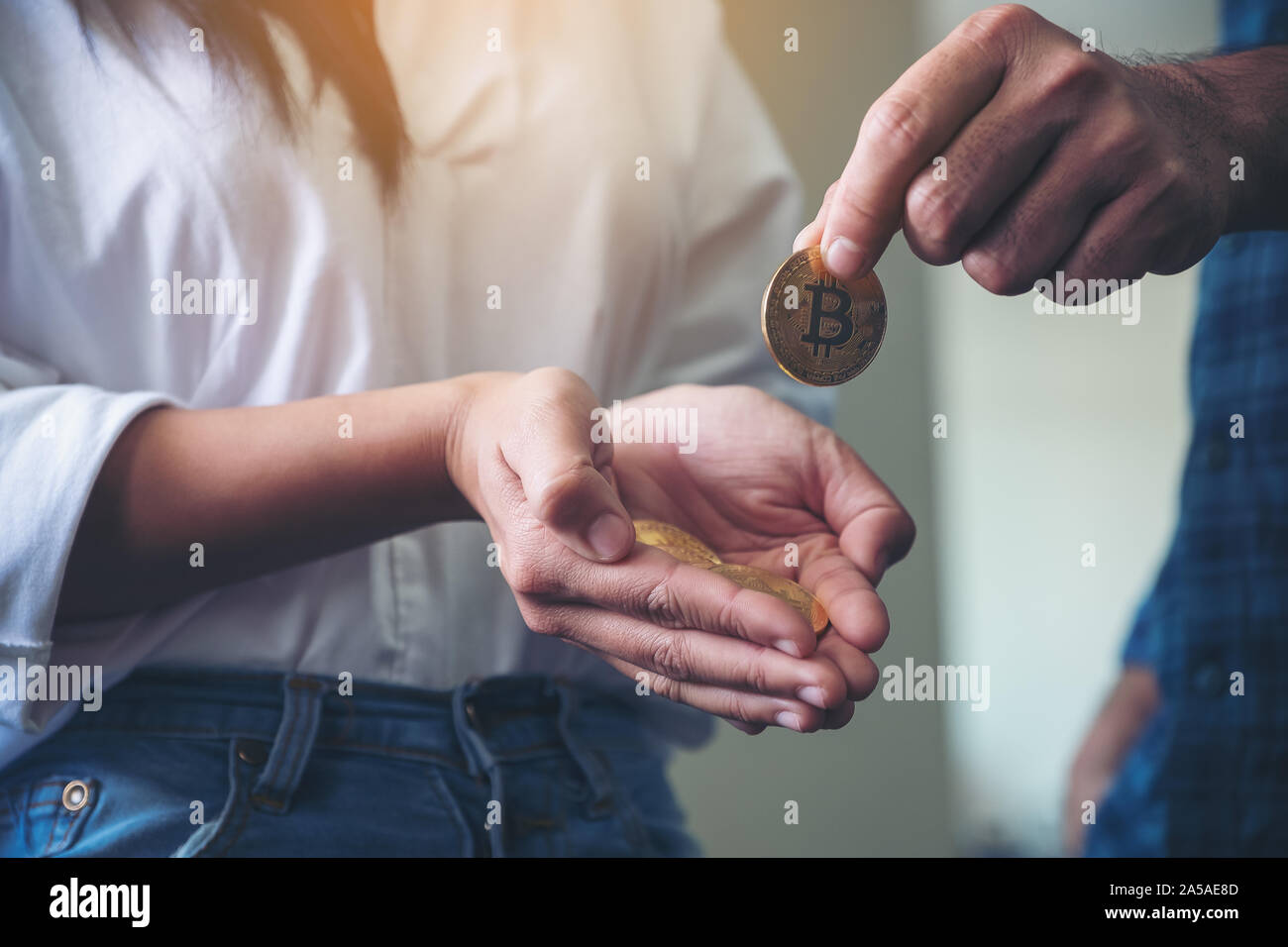 Closeup image of people giving and collecting bitcoins Stock Photo - Alamy