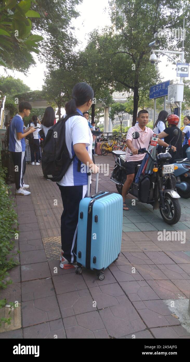 Shenzhen, China: boarding high school students waiting for school bus ...