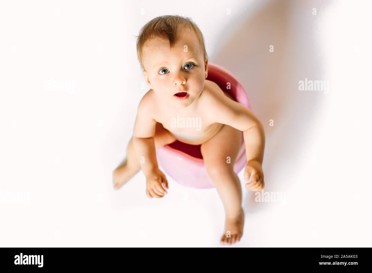 Cute little girl at home is sitting on the chamber pot , concept of ...